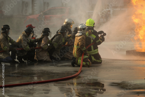 Firefighters using Twirl water fog type fire extinguisher to fighting ...