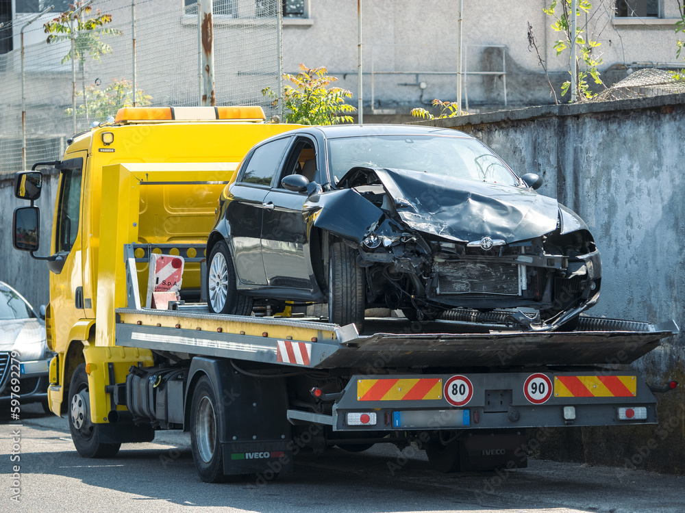 Alfa Romeo badly crashed frontally,loaded onto flatbed tow truck.Milan ...