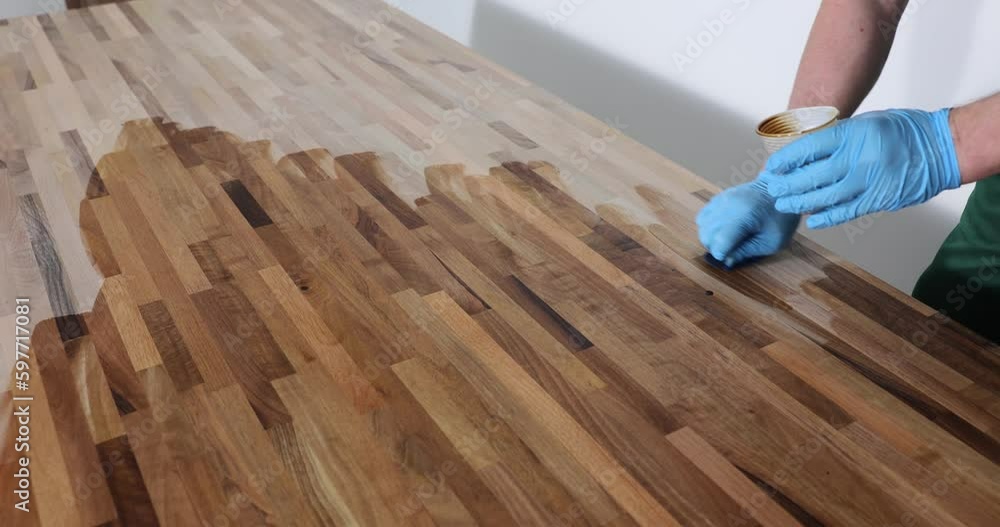 Vidéo Stock Male skilled carpenter covers surface of wooden office ...