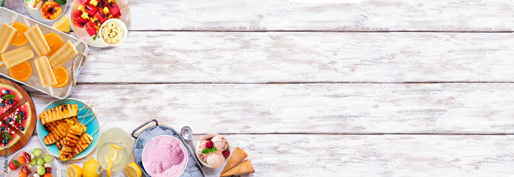 Refreshing summer food corner border. Assortment of grilled fruits, ice ...