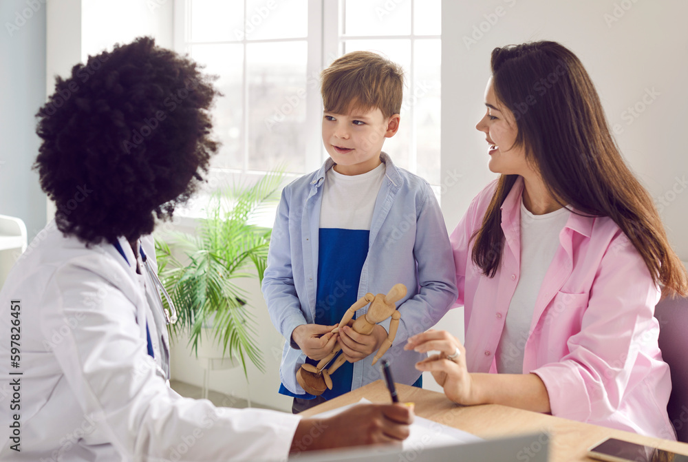 Child patient with his mother at a medical examination in the doctor's ...