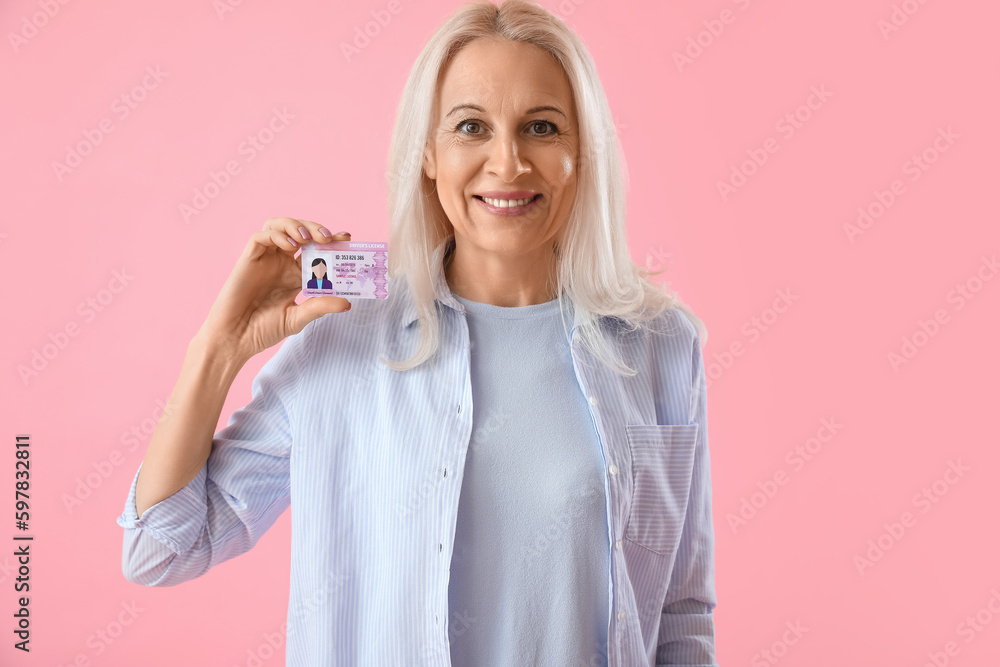Mature woman with driving license on pink background Stock Photo ...