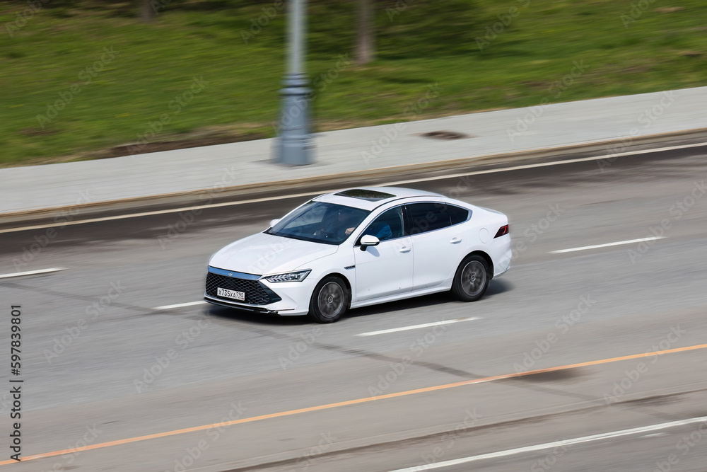 BYD Qin Pro car rides on the road. Aerial front side view of modern ...