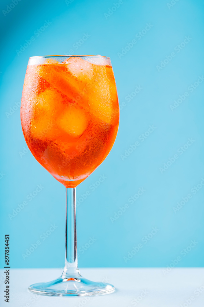 Aperol Spritz cocktail in glass on a blue background. Classic italian ...