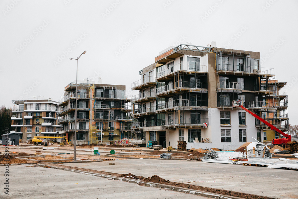 Construction site background. Hoisting cranes and new multi-storey ...