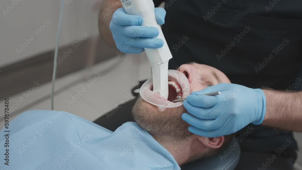 Orthodontist using 3D intraoral scanner for scanning teeth patient's ...
