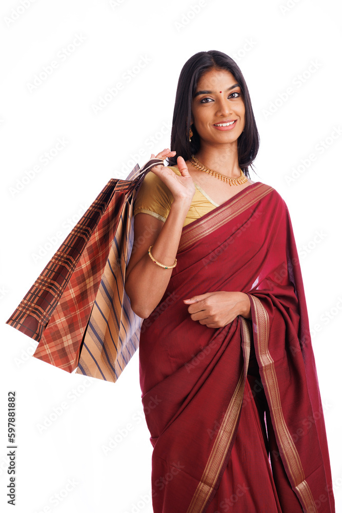Beautiful Indian traditional woman holding shopping bags and smiling ...
