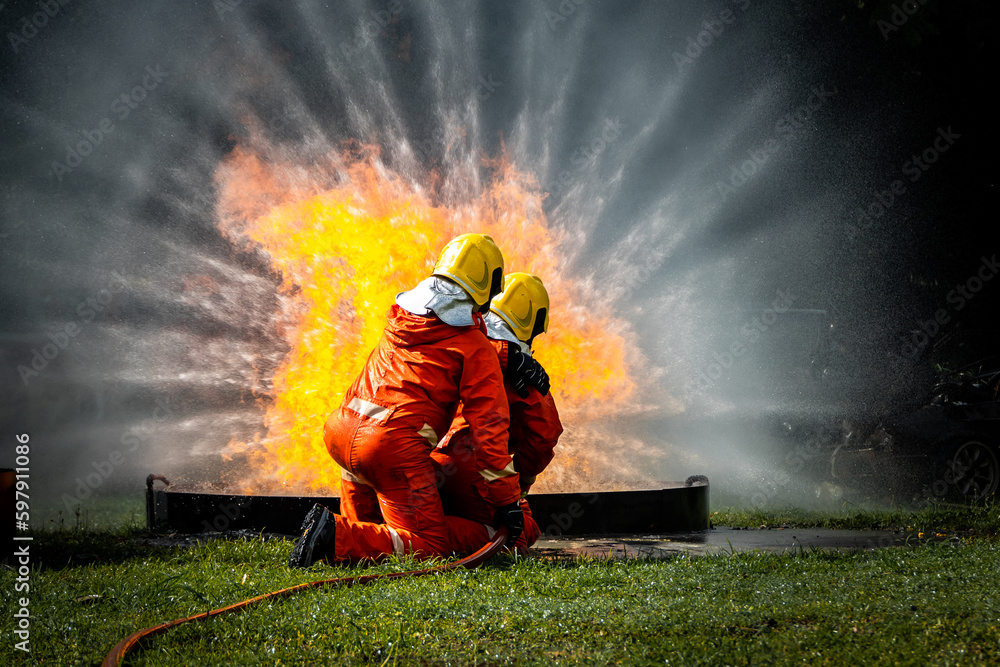 Firefighter Concept. Fireman using water and extinguisher to fighting ...