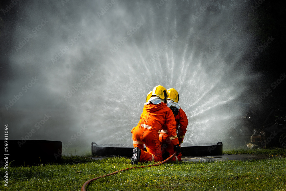 Firefighter Concept. Fireman using water and extinguisher to fighting ...