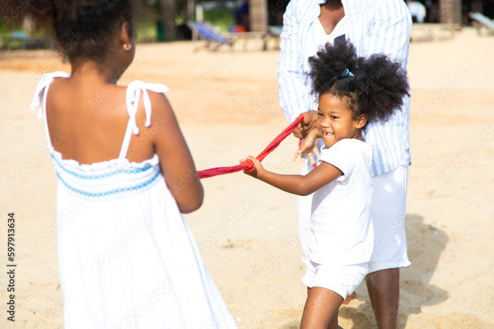 Black family having fun on the beach. mixed race family competing in ...