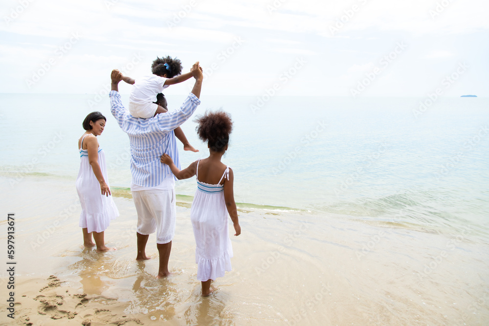 Black family having fun on the beach. mixed race family relaxing at the ...