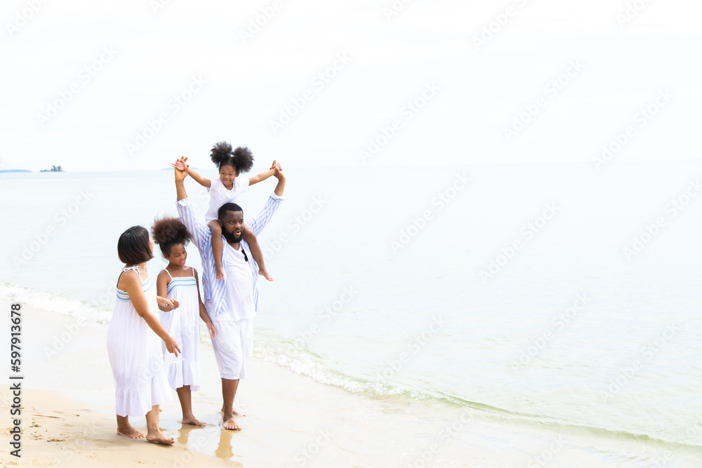 Black family having fun on the beach. mixed race family relaxing at the ...