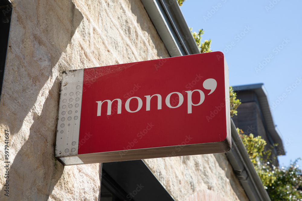 Monop' logo sign and text brand on city building of supermarket facade ...