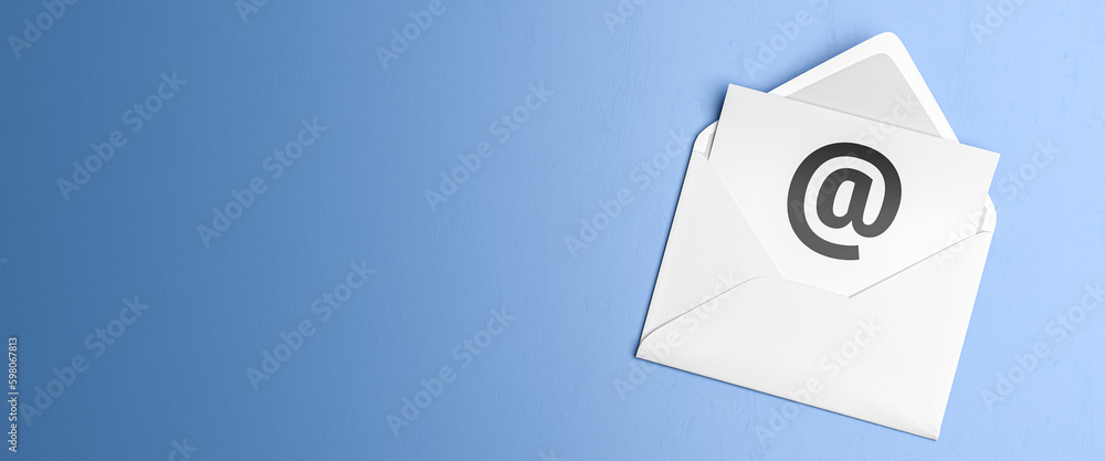 Letter with an at sign in an envelope on blue table background. Email ...