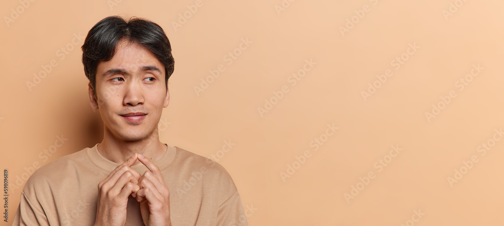 Handsome Chinese man with dark hair has devious plan cunning face keeps ...