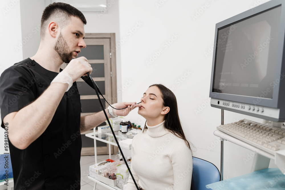 ENT doctor using fibrolaryngoscope to examine and treat nose. ENT ...