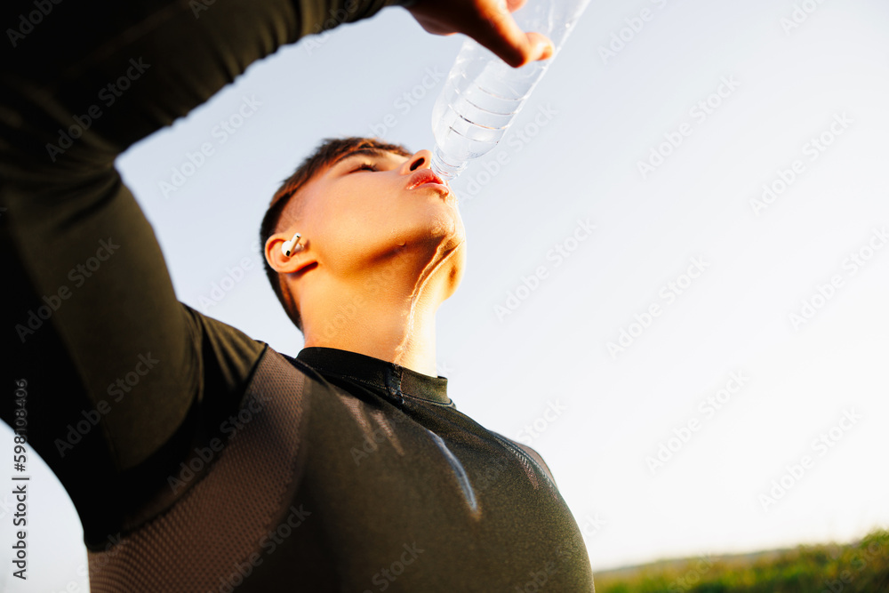 man holding clean fresh mineral water bottle with court background ...