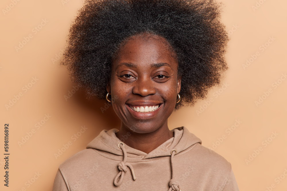 Headshot of black ethnic woman with bushy hair smiles broadly has white ...