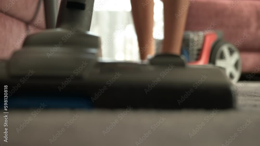 Girl feet by vacuums device. A girl with bare feet walk with vacuum ...
