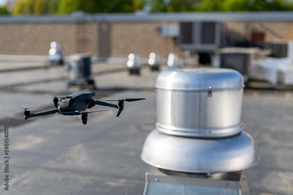 Drone being used to perform an aerial inspecting of HVAC RTU equipment ...
