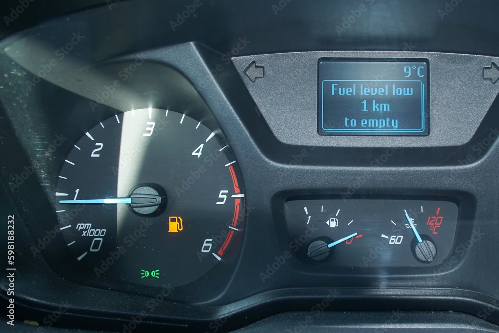 Dashboard close-up. Critical fuel level. Remaining fuel per kilometer ...