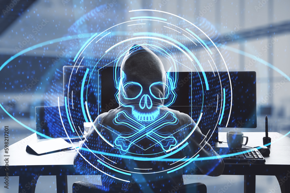 Back view of hacker using laptop with abstract glowing skull hologram ...