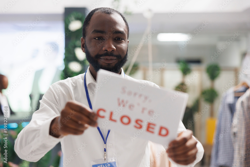 Fashion garment department store african american employee hanging ...