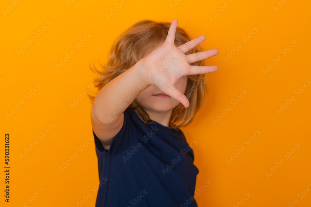 Child making stop gesture on isolated studio background. Kid showing ...