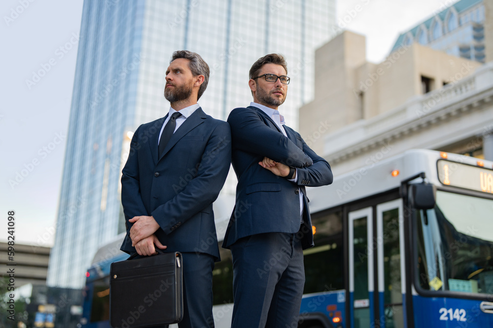 Successful business men posing outdoor in american city street ...