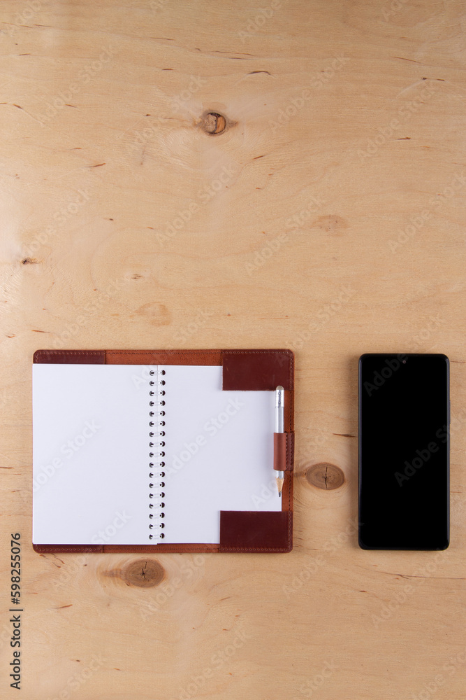 Digitalization concept. Paper notebook vs smartphone. Digital phone ...
