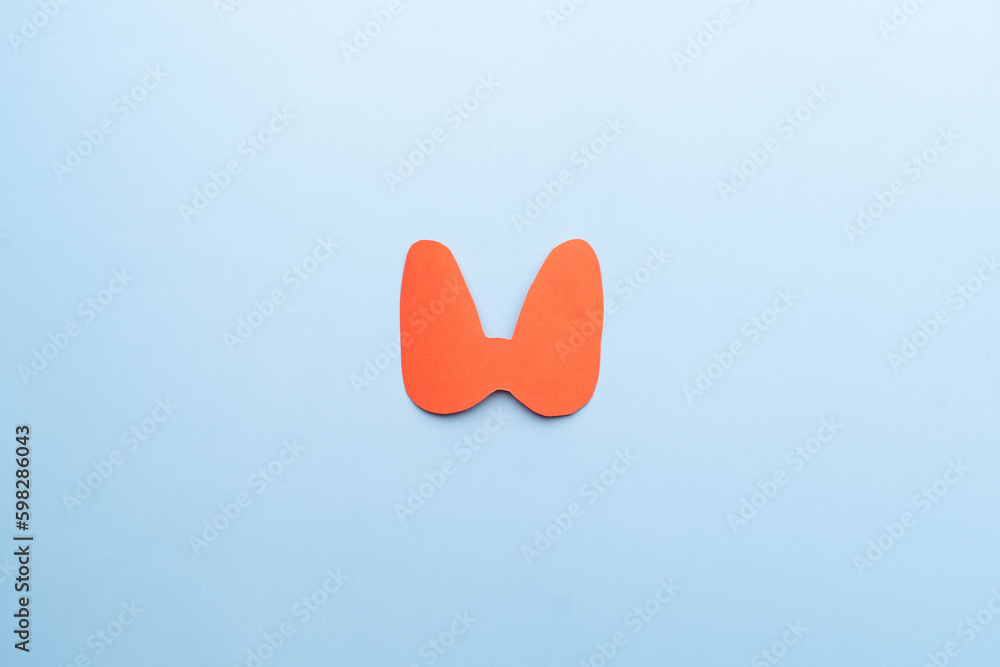 Foto de World Thyroid Day concept. Thyroid gland shape made from paper ...