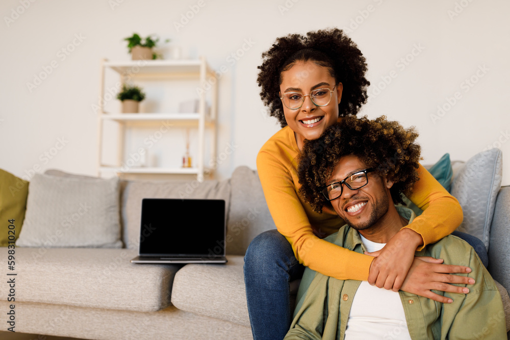Black Couple Posing With Laptop, Embracing Smiling To Camera Indoors ...