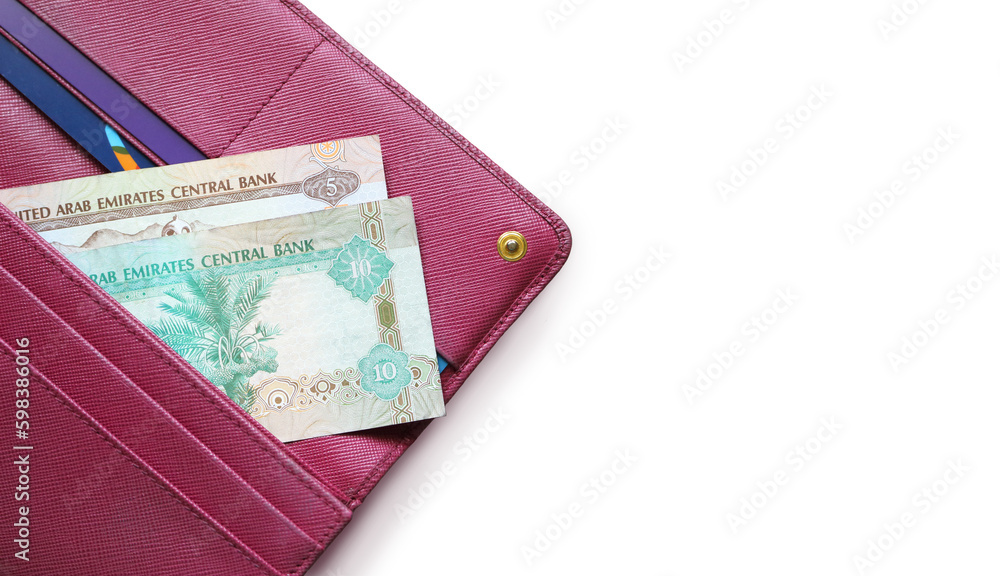 UAE dirham bills in a leather wallet. Fucsia red wallet, purse. Wood ...