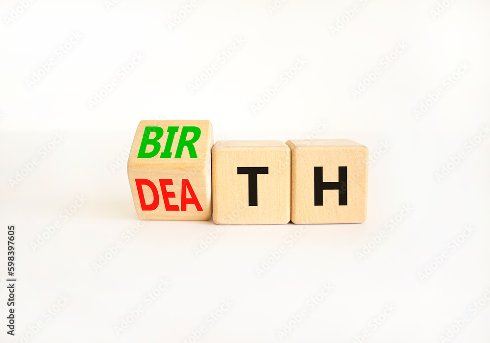 Birth or death symbol. Businessman turns wooden cubes and changes the ...