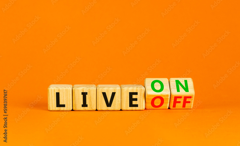 Live on or off symbol. Businessman turns wooden cubes and changes word ...