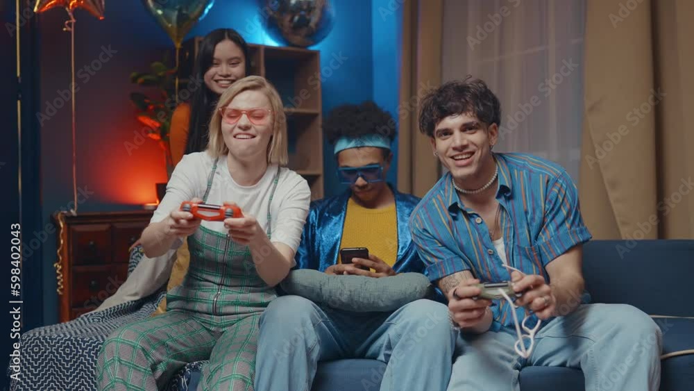 Group of friends making party at home and playing video games in the ...