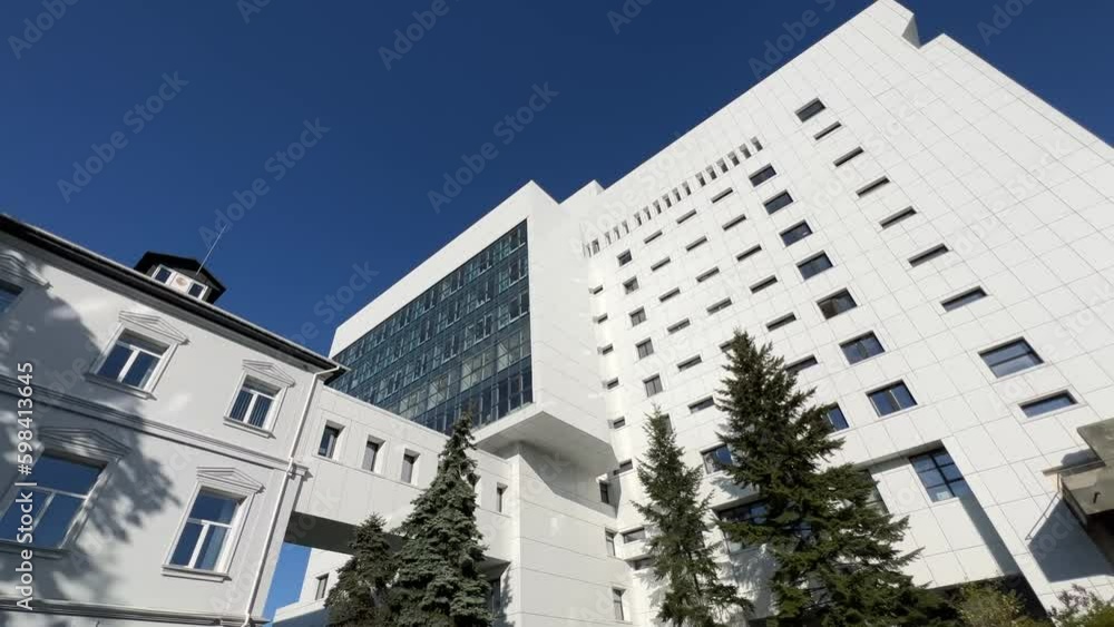 Hospital exterior with transition between buildings. Bottom up view of ...