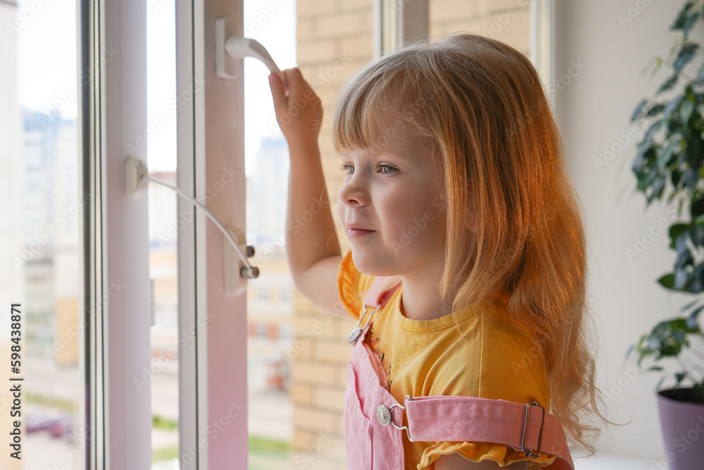 safety at home for small children. a lock on the window protects ...