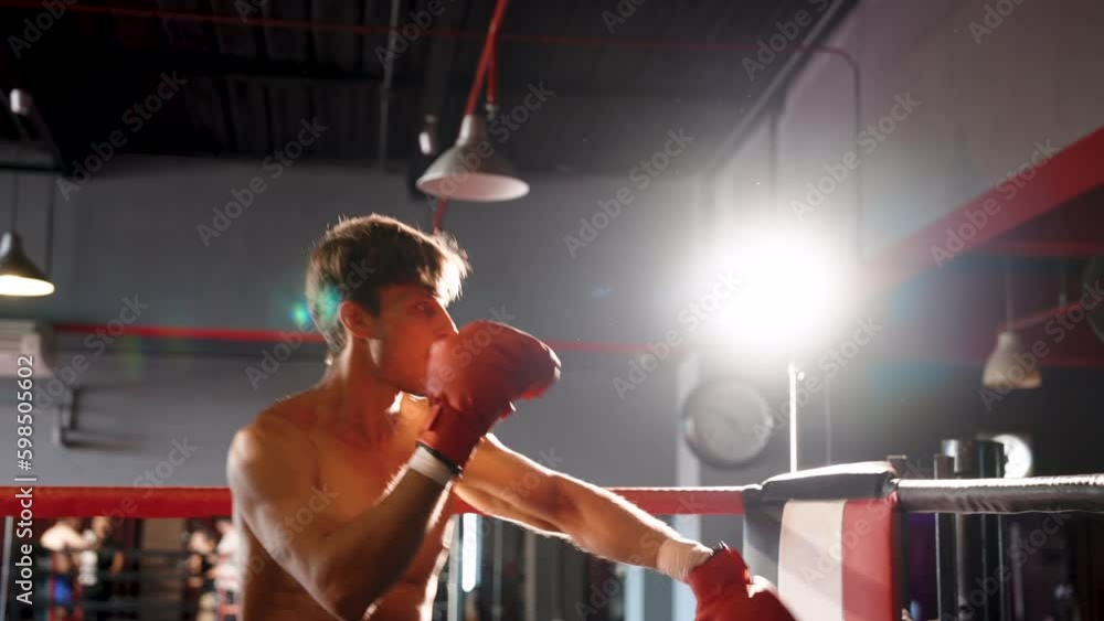 Strong caucasian athletic boxer warming up to prepare for boxing in the ...