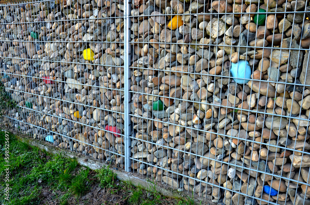 gabion fences filled with pebbles and quartz stones. some are colored ...