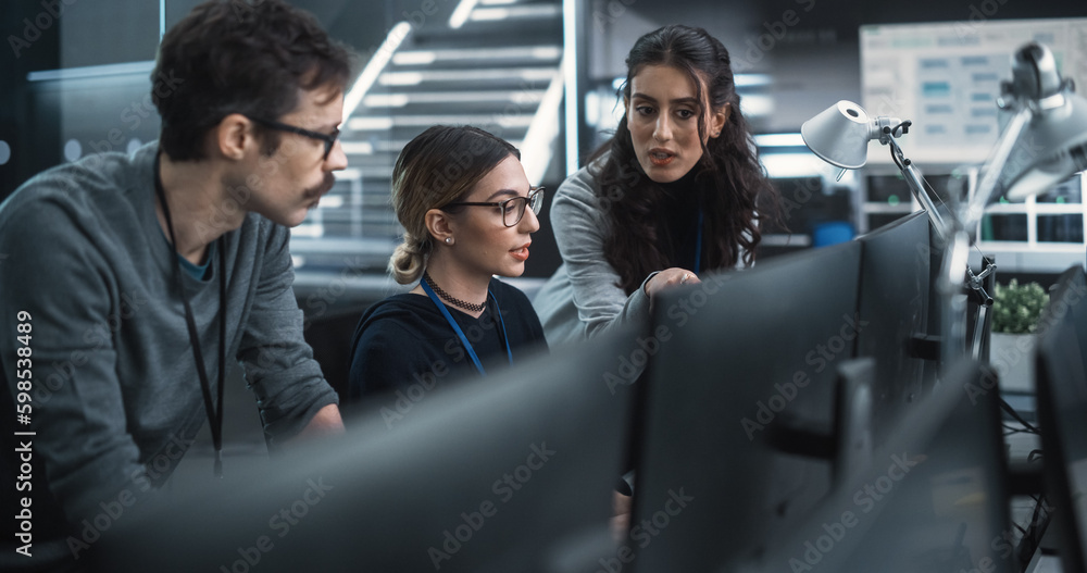 Team of Three Talented Young Software Engineers Use Computer to Discuss ...