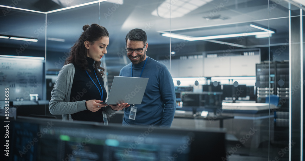 Portrait of Two Happy Female and Male Engineers Using Laptop Computer ...