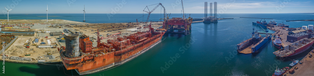 Oil rig and tanker in port for maintenance work. Oil terminal with ...