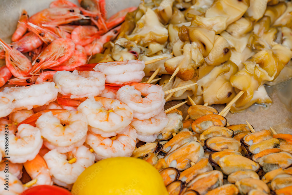 Shrimp, mussel meat and rapana cooked on wooden skewers Stock Photo ...