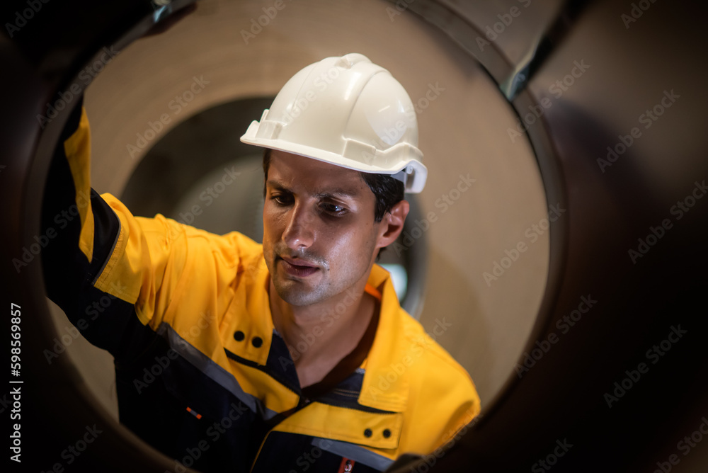 brazilian or latin worker wearing safety uniform workwear, working to ...