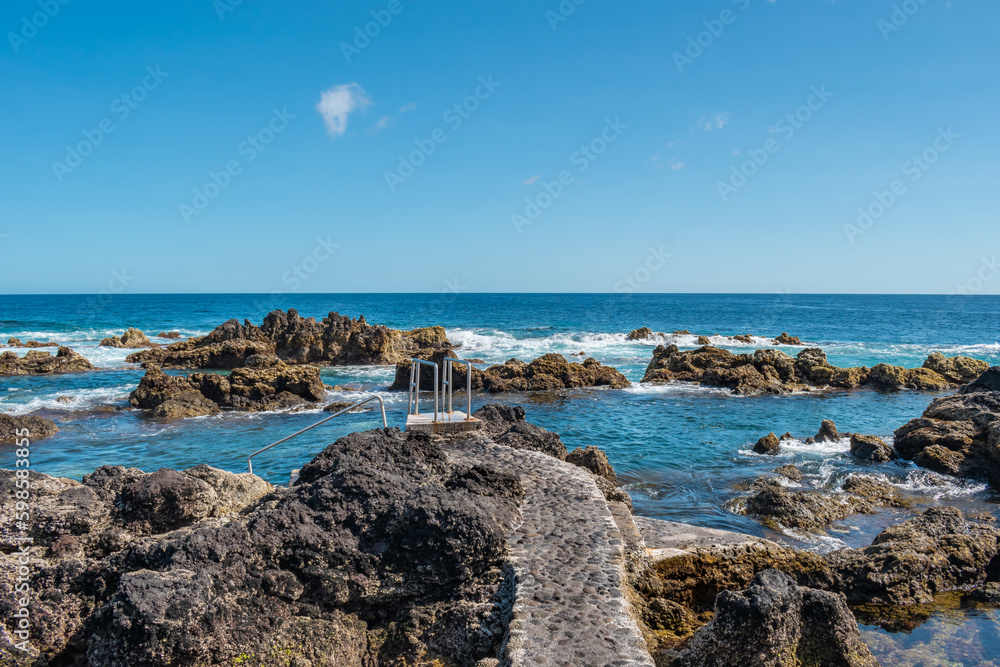 Stone pathway in volcanic rock in the natural sea pools in Biscoitos on ...