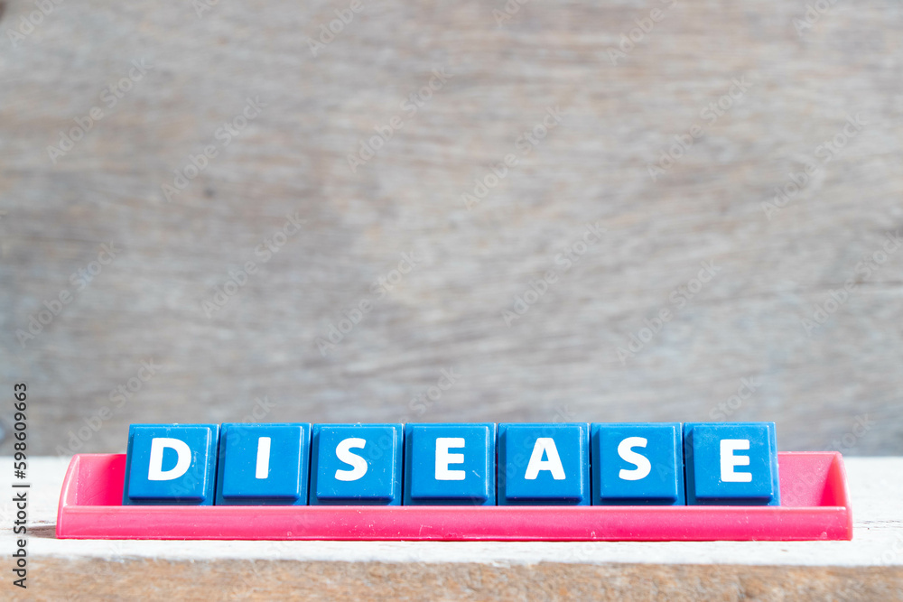 Tile alphabet letter with word disease in red color rack on wood ...