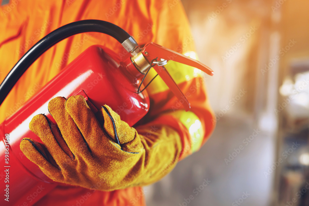 hand presses the trigger fire extinguisher available in fire ...