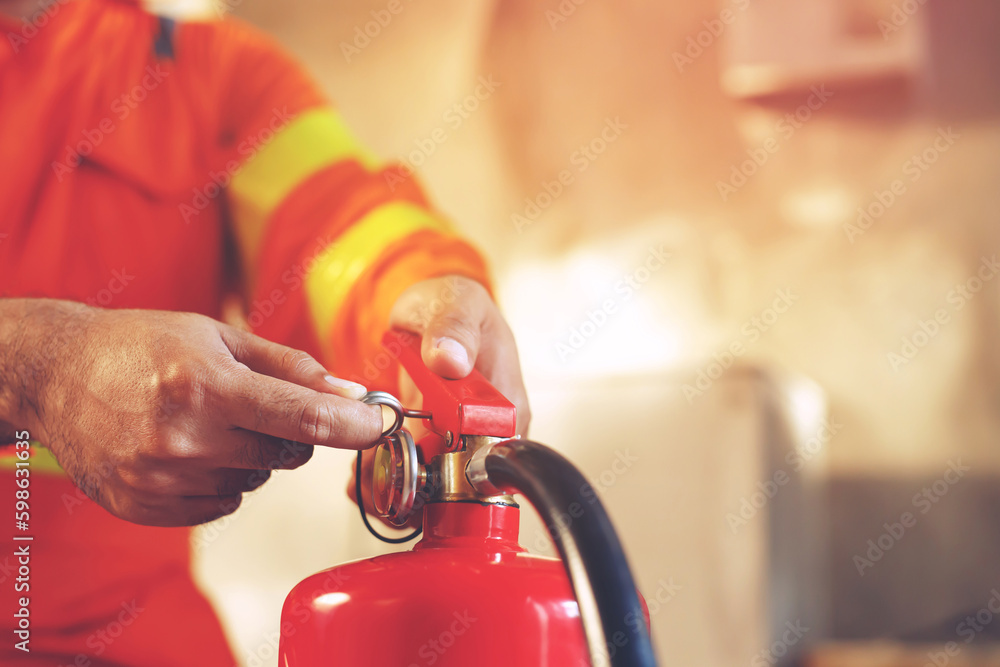 hand presses the trigger fire extinguisher available in fire ...