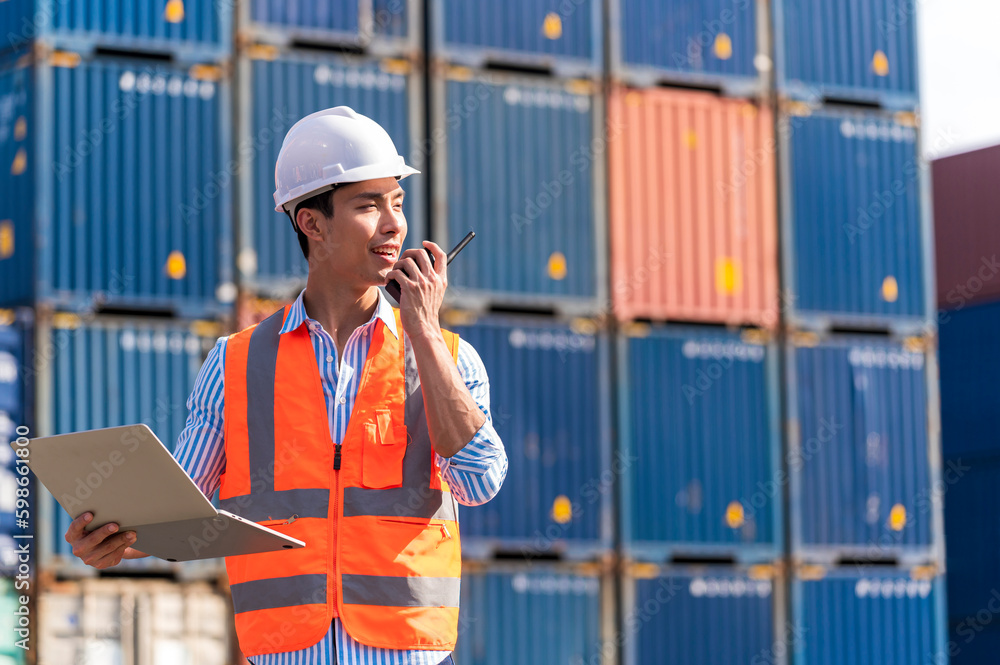 Happy Asian dock control working with smile around Shipping container ...